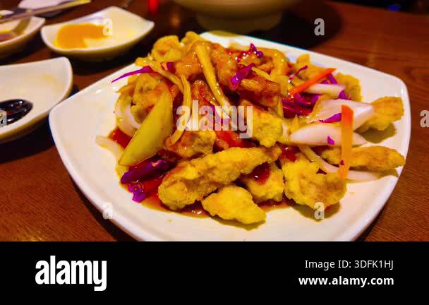 Motion video of Sweet and sour sauce fried with pork on dish in the ...