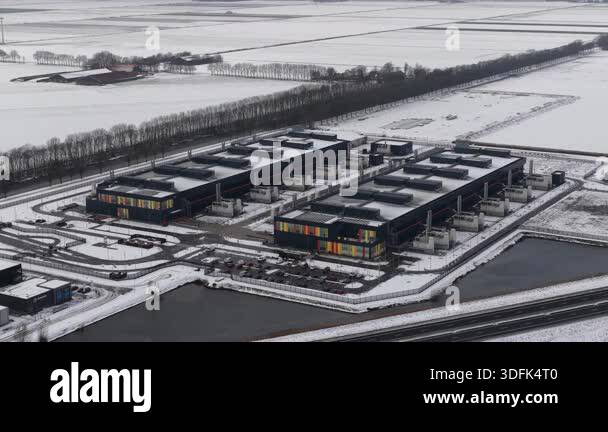Aerial drone video of a datacenter in winter, showing cloud ...