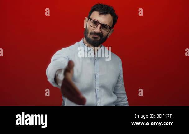 Man with beard and glasses extending hand for handshake against vibrant ...
