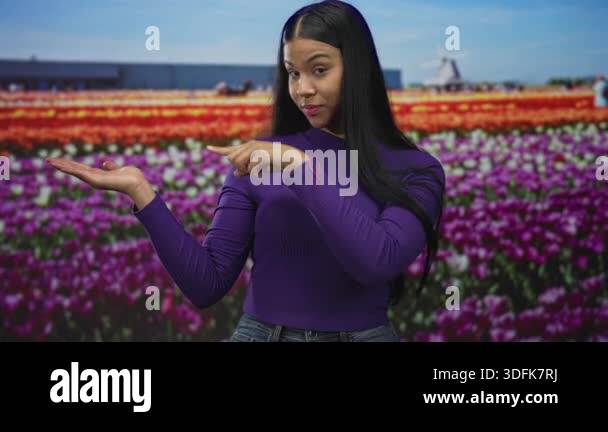 Smiling latin woman shows ok sign with hand held above open palm among ...