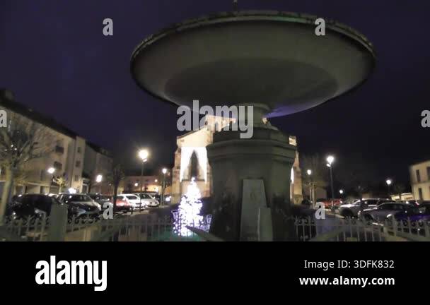 Light changing dry fountain with Christmas lights in background Stock ...