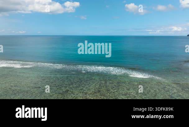 Clear sea water and waves in Busuanga. Blue sky and clouds. Palawan ...