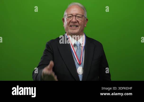 Senior man in a business suit with a silver medal smiles against an ...