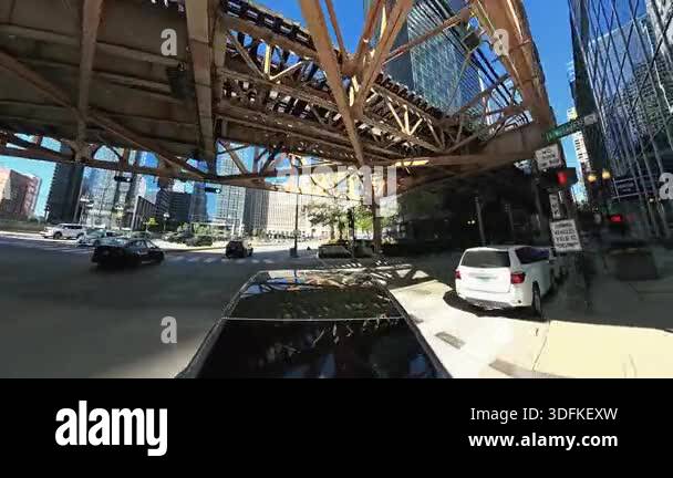 POV driving under Chicago elevated train tracks, showing steel beams ...