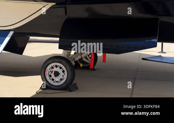 POV Close-up of a military aircraft landing gear secured with wheel ...