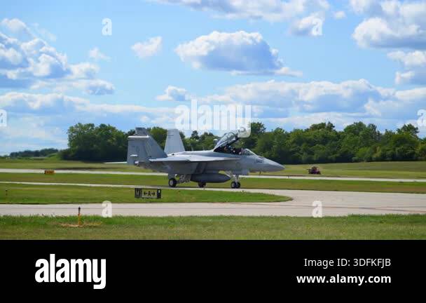 Military fighter jet moves along runway with cockpit canopy open as ...
