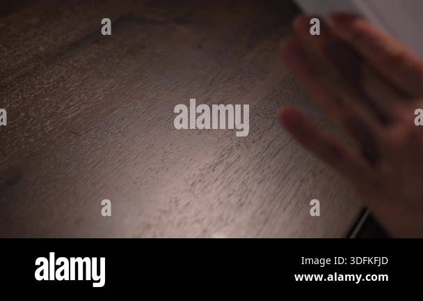 Closed iPhone 17 retail box placed on a wooden table, showing the ...