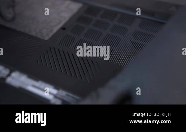 Opening the computer back cover and showing close-up view of a laptop ...