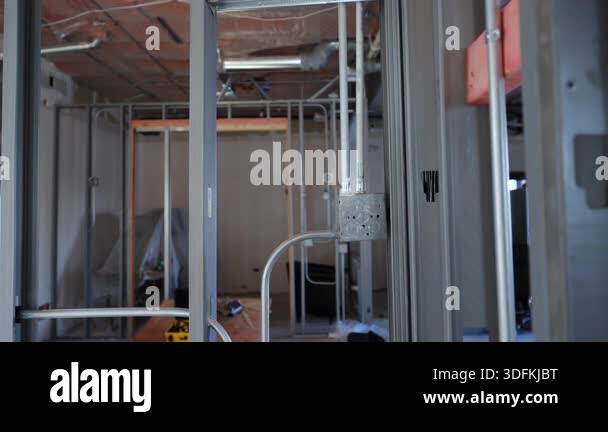 POV of unfinished interior with metal wall framing, plumbing pipes ...