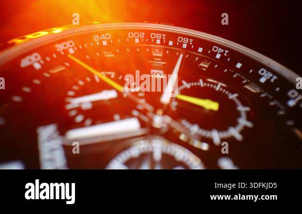 Macro close-up of luxury chronograph watch illuminated by intense ...