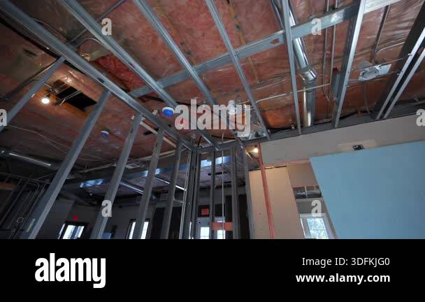 POV of unfinished interior ceiling with HVAC ducts, plumbing lines, and ...