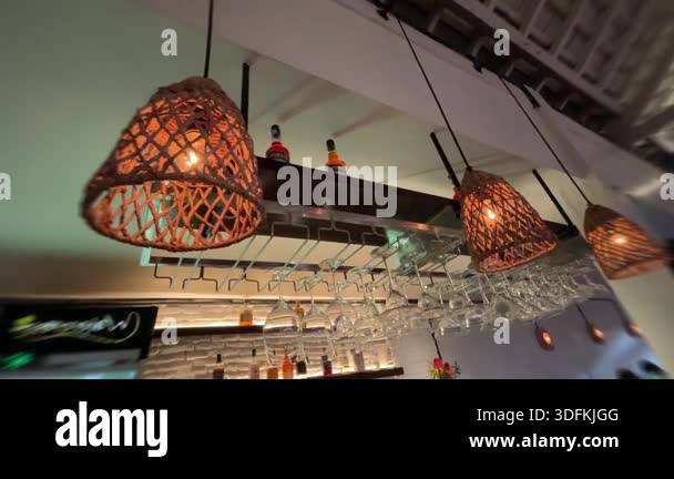 Warm Rattan Pendant Lights Over Bar, Bottles Lined On Wooden Shelf ...