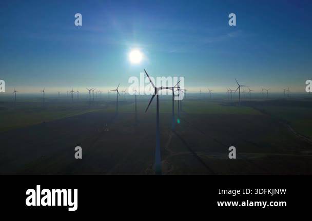 Wind turbines rotating in a vast rural landscape, providing clean ...