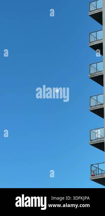 A plastic bag moves swiftly around the windows of a high-rise building ...