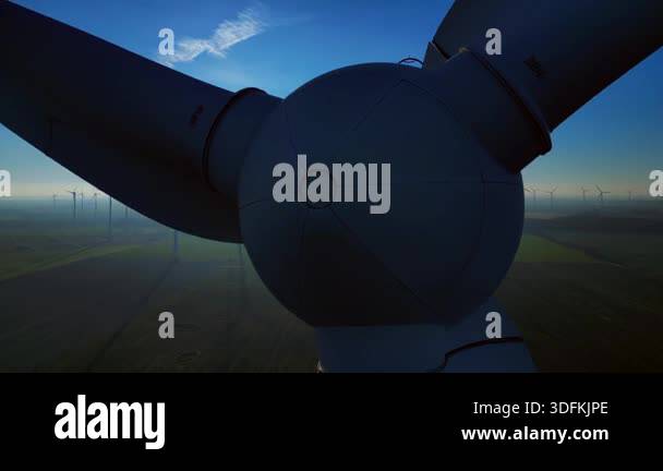 Wind turbines rotating in a vast rural landscape, providing clean ...