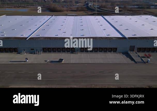Aerial view of a wide distribution center building, featuring numerous ...