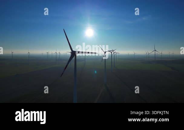 Wind turbines rotating in a vast rural landscape, providing clean ...