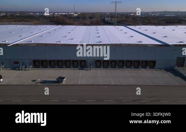 Aerial view of a wide distribution center building, featuring numerous ...