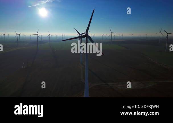 Wind turbines rotating in a vast rural landscape, providing clean ...