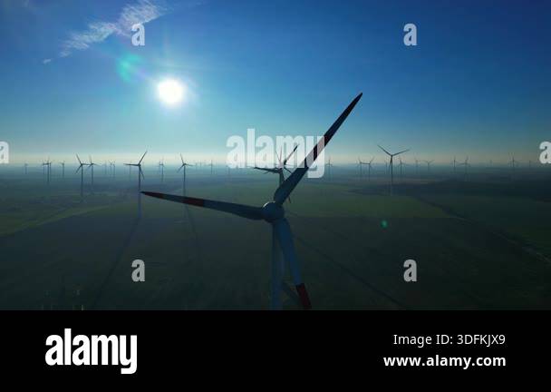 Wind turbines rotating in a vast rural landscape, providing clean ...