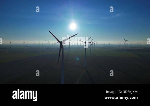 Wind turbines rotating in a vast rural landscape, providing clean ...