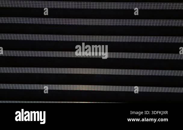 Large grid of photovoltaic solar panels from an aerial view, producing ...