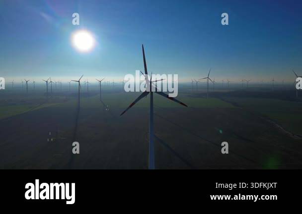 Wind turbines rotating in a vast rural landscape, providing clean ...