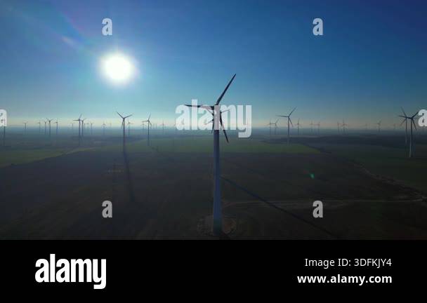 Wind turbines rotating in a vast rural landscape, providing clean ...