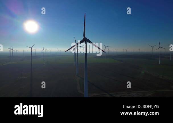 Wind turbines rotating in a vast rural landscape, providing clean ...