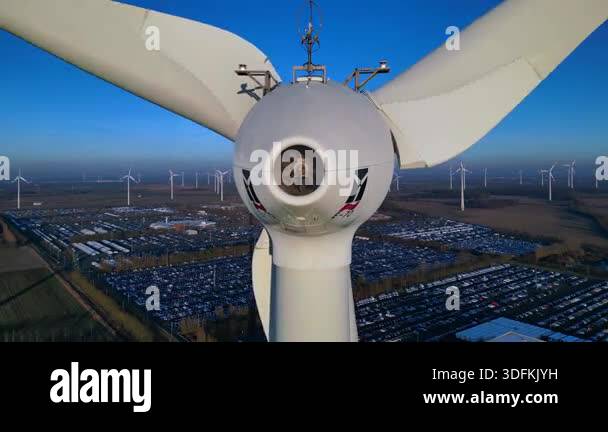 closup of Wind turbine close up with many turbines, solar panels, and a ...