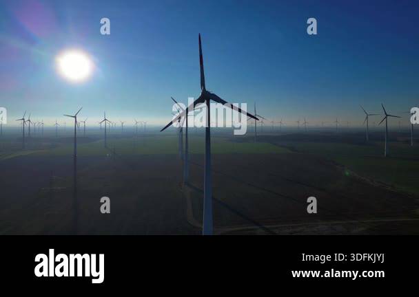 Wind turbines rotating in a vast rural landscape, providing clean ...
