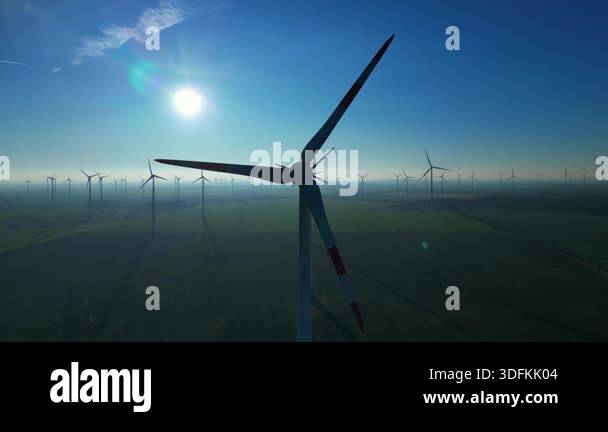 Wind turbines rotating in a vast rural landscape, providing clean ...