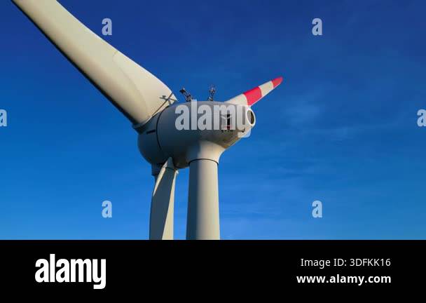 closup of Wind turbine close up with many turbines, solar panels, and a ...