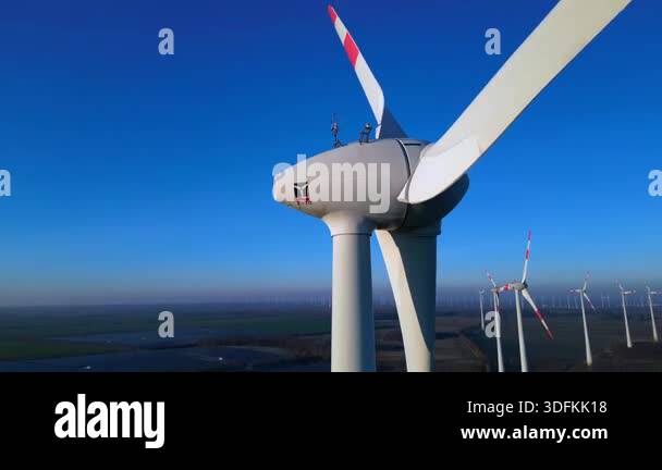 closup of Wind turbine close up with many turbines, solar panels, and a ...