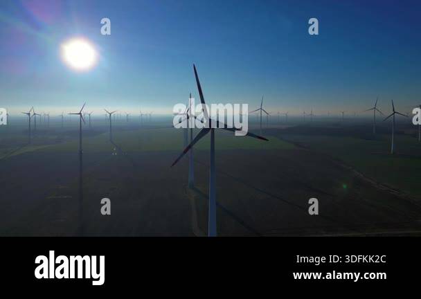 Wind turbines rotating in a vast rural landscape, providing clean ...