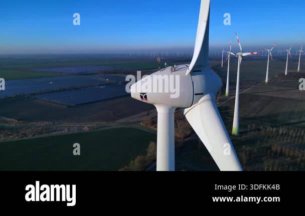 closup of Wind turbine close up with many turbines, solar panels, and a ...