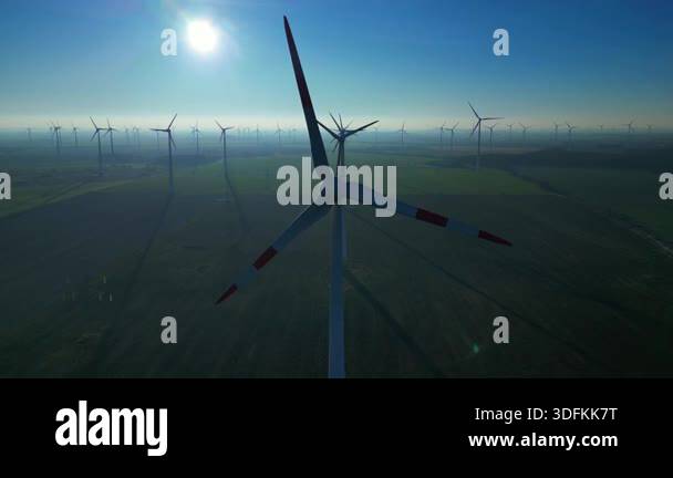 Wind turbines rotating in a vast rural landscape, providing clean ...