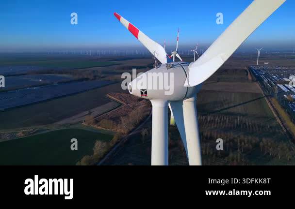 closup of Wind turbine close up with many turbines, solar panels, and a ...