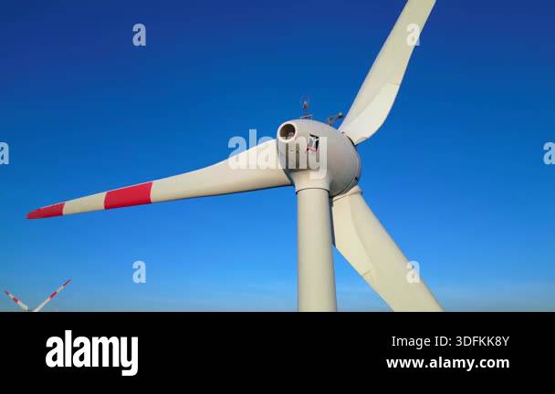 closup of Wind turbine close up with many turbines, solar panels, and a ...