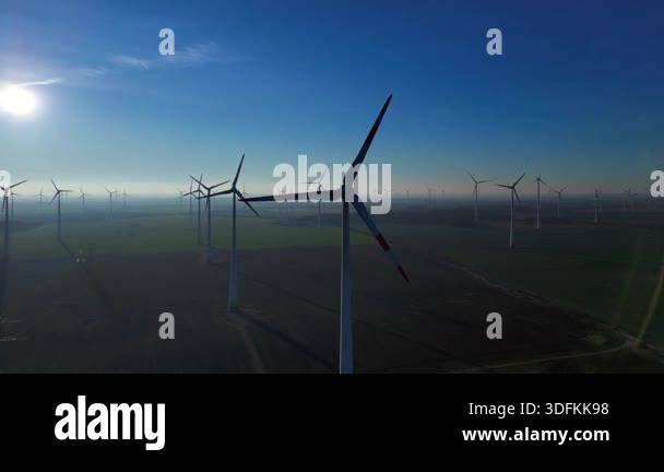 Wind turbines rotating in a vast rural landscape, providing clean ...
