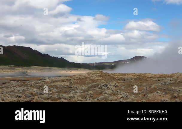 Volcanic landscape with hot sulfur steam rising from a geothermal field ...