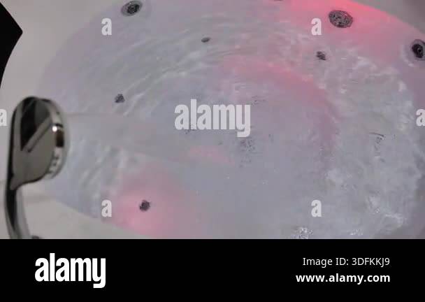 Jacuzzi.Bathing in a jacuzzi. Water bubbling in a jacuzzi with changing ...