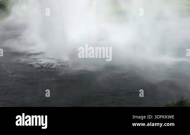 Closeup of a powerful waterfall base hitting the water surface and ...