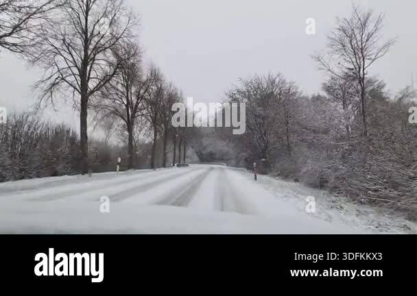 Point of view from a car driving on a dangerous slippery road during a ...