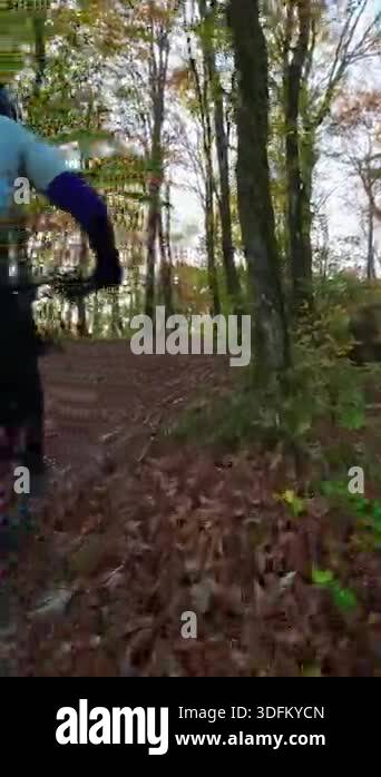 Vertical aerial FPV drone footage of a rider in blue gear navigates a ...