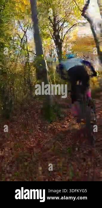 Vertical aerial FPV drone footage of a rider in blue gear navigates a ...