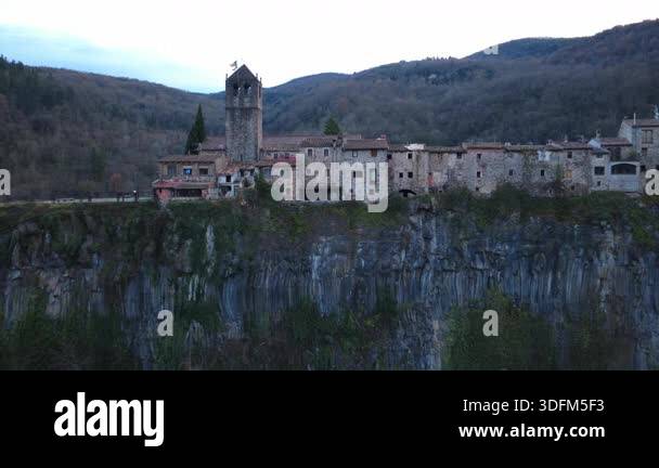 Aerial side view of Castellfollit de la Roca village built atop ...