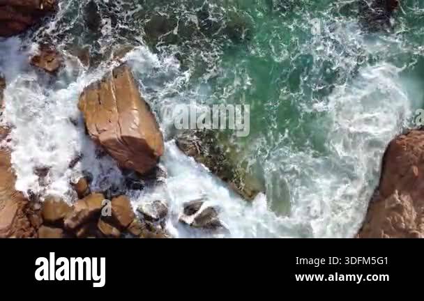Powerful ocean waves hitting rocks and cliffs along the rugged ...