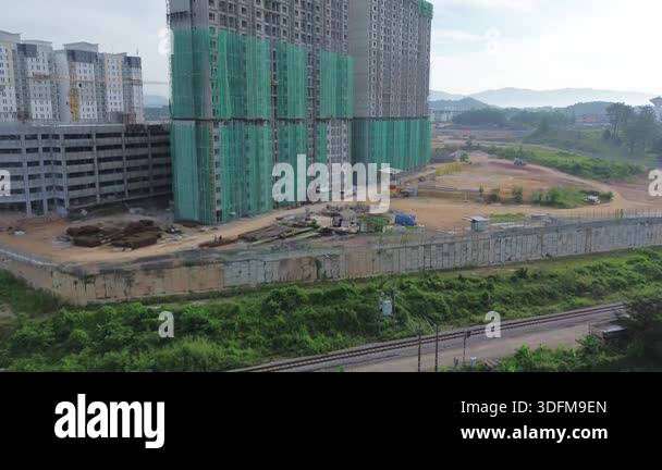 Drone fly-up revealing a massive high-rise apartment construction site ...