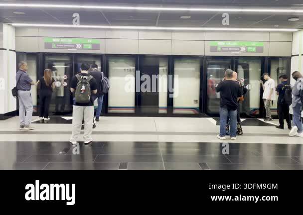 Kuala Lumpur - December 18 , 2025 : Commuters standing on a platform ...